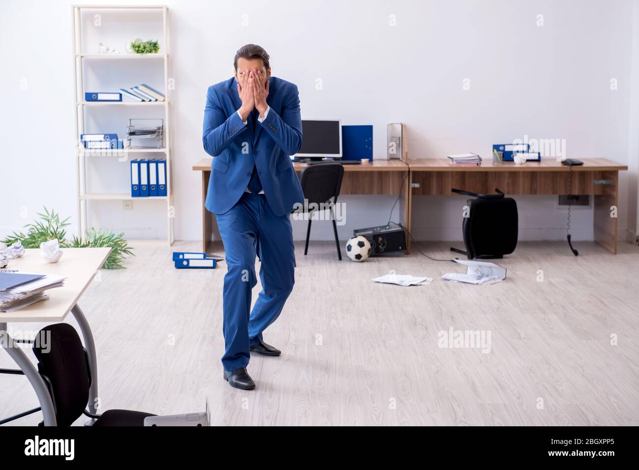 Young employee playing football in the office Stock Photo - Alamy