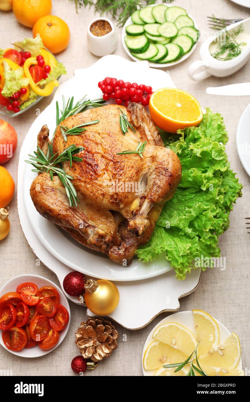 Baked chicken for festive dinner. Christmas table setting Stock Photo ...
