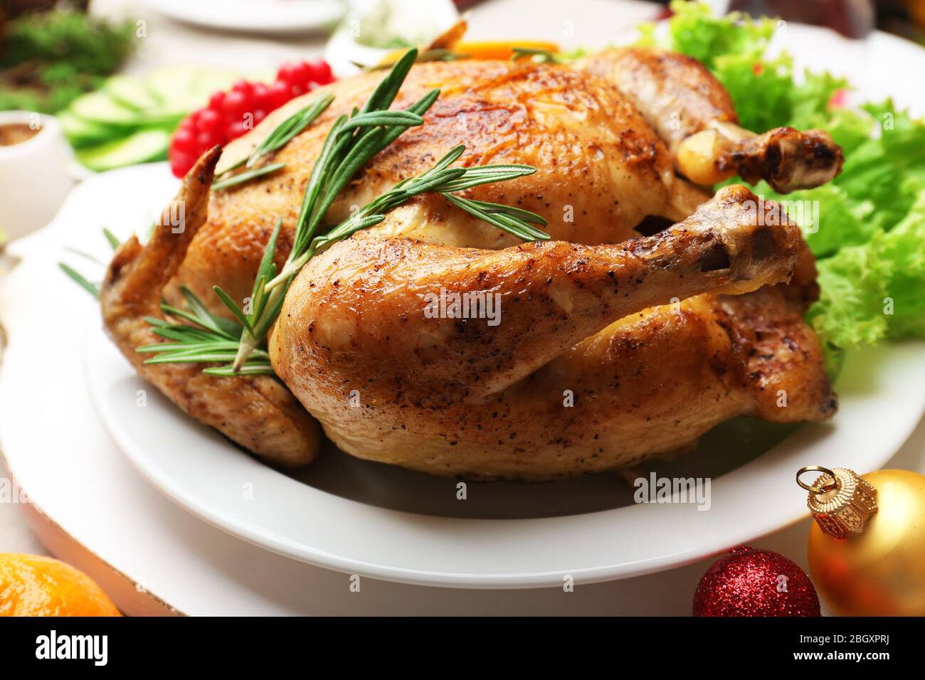Baked chicken for festive dinner. Christmas table setting Stock Photo ...