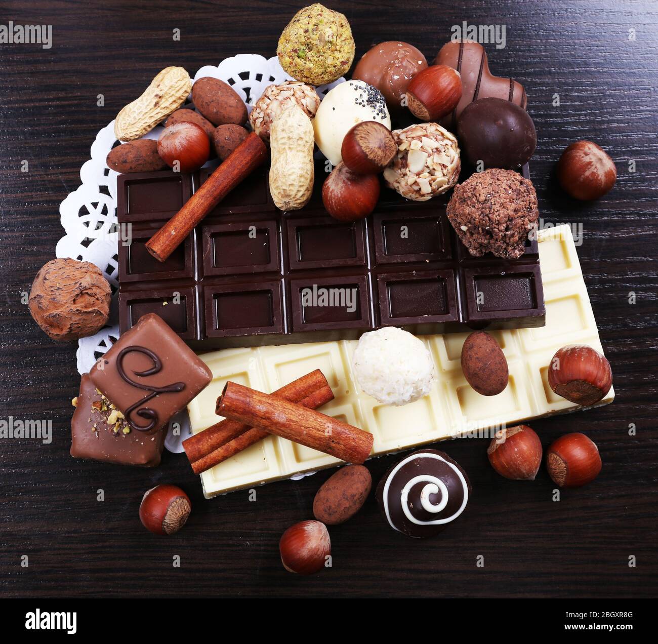 Bars of white and bitter chocolates with candies, hazelnut and cinnamon ...