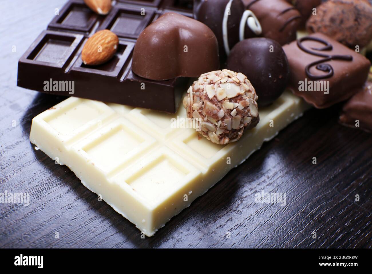 Bars of white and bitter chocolates with candies, cinnamon stick and ...