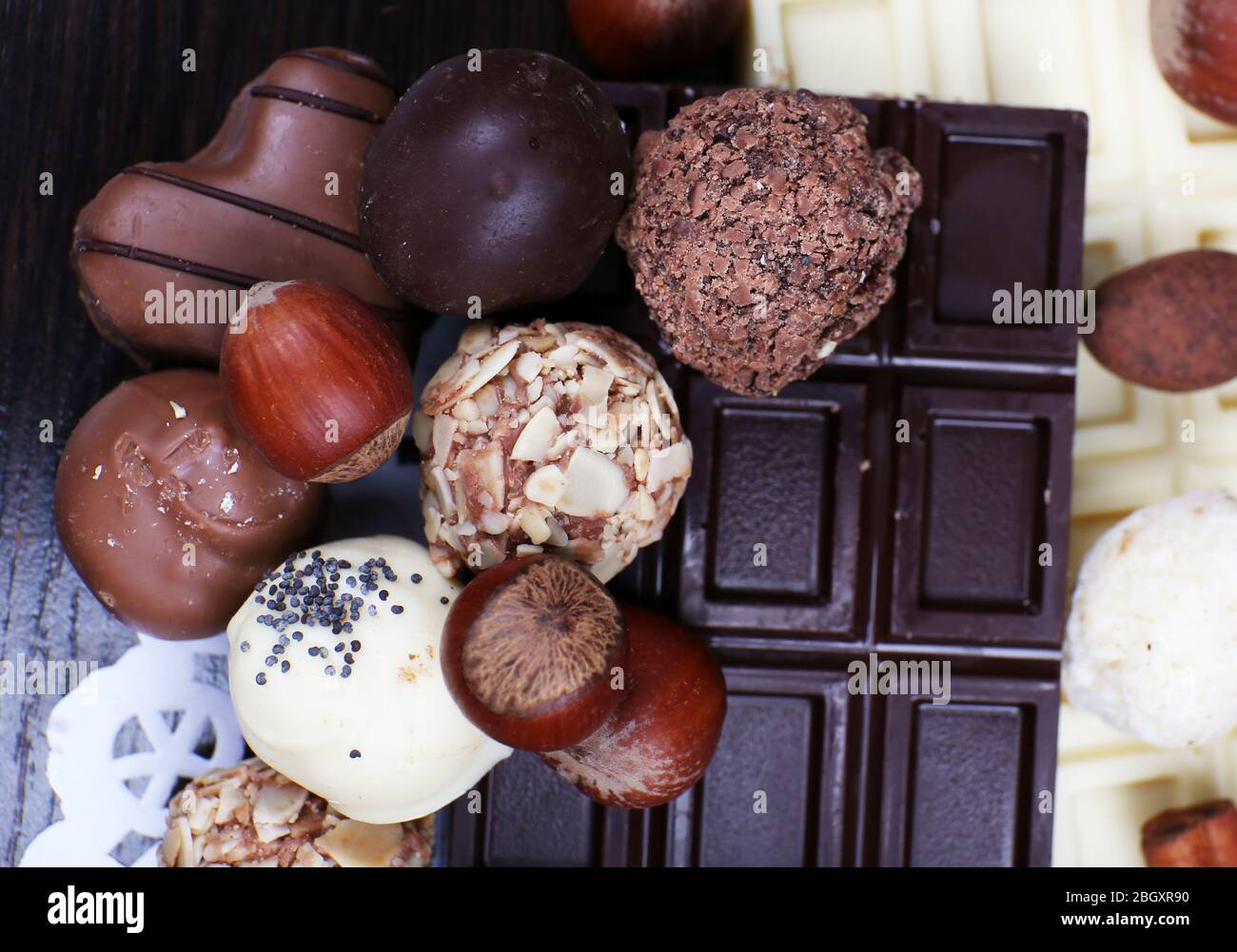Bars of white and bitter chocolates with candies, hazelnut and cinnamon ...