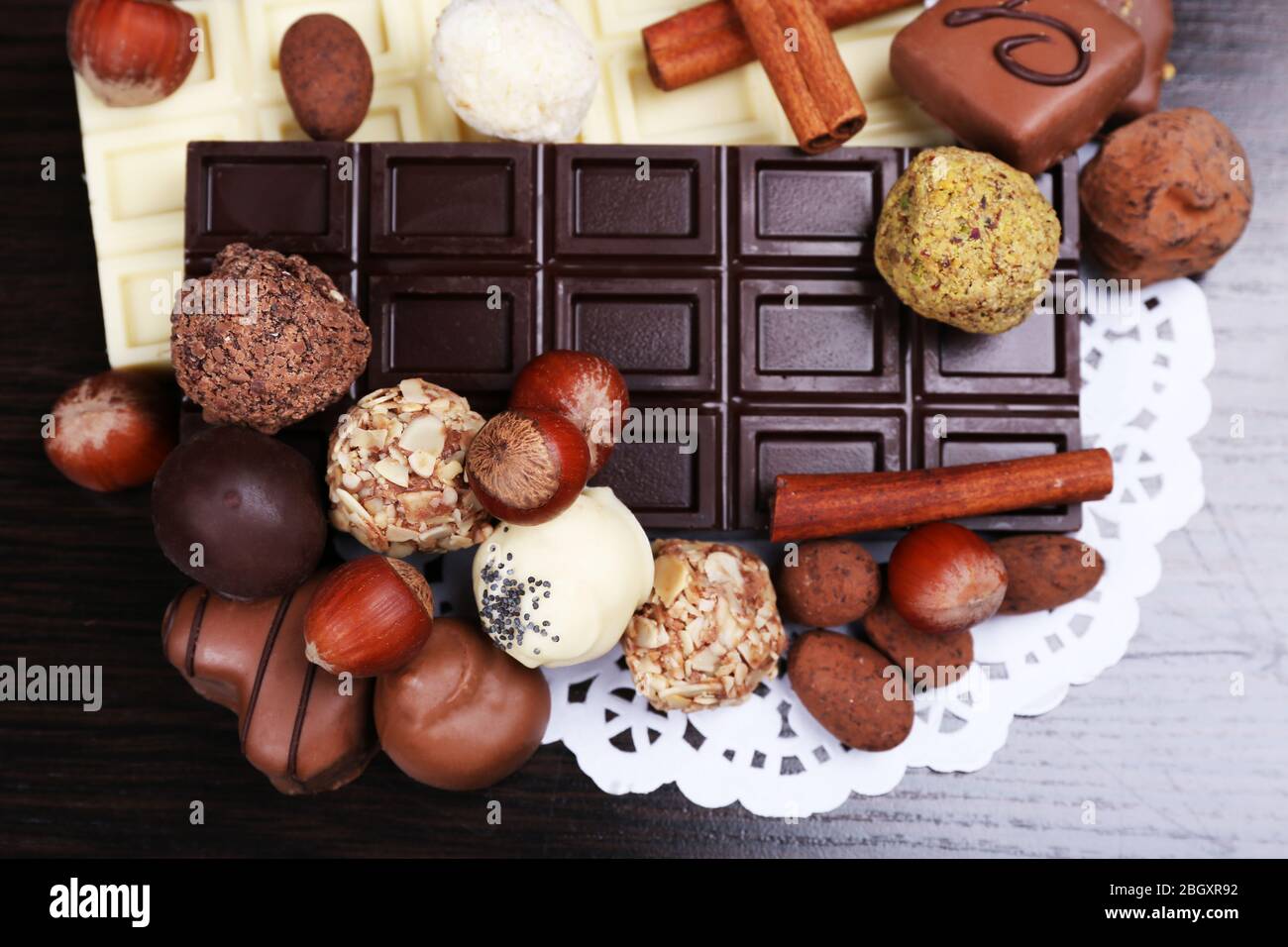 Bars of white and bitter chocolates with candies, hazelnut and cinnamon ...