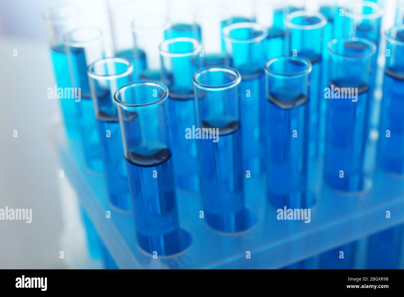 Blue water in a transparent test-tube on light background Stock Photo ...