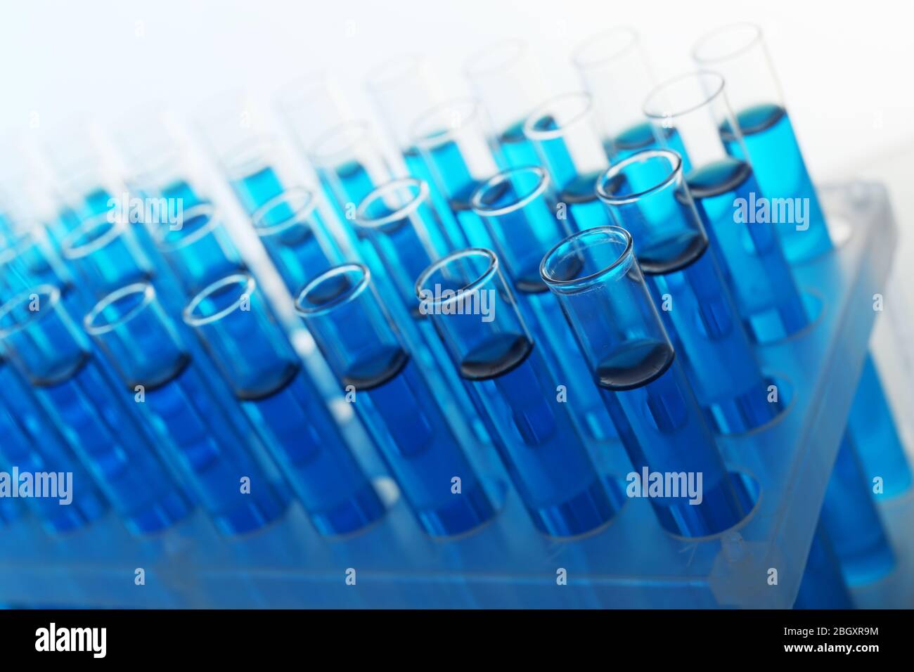 Blue water in a transparent test-tube on light background Stock Photo ...