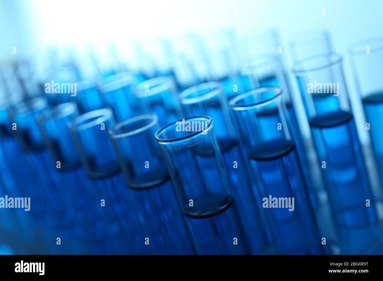 Blue water in a transparent test-tube on light background Stock Photo ...