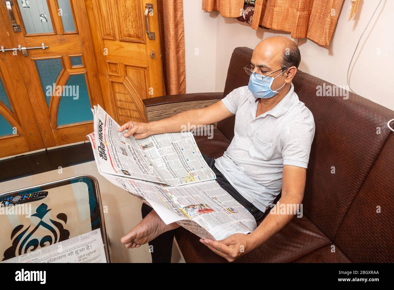 Jodhpur, Rajashtbn, India. 30 March 2020. Man wearing mask reading ...