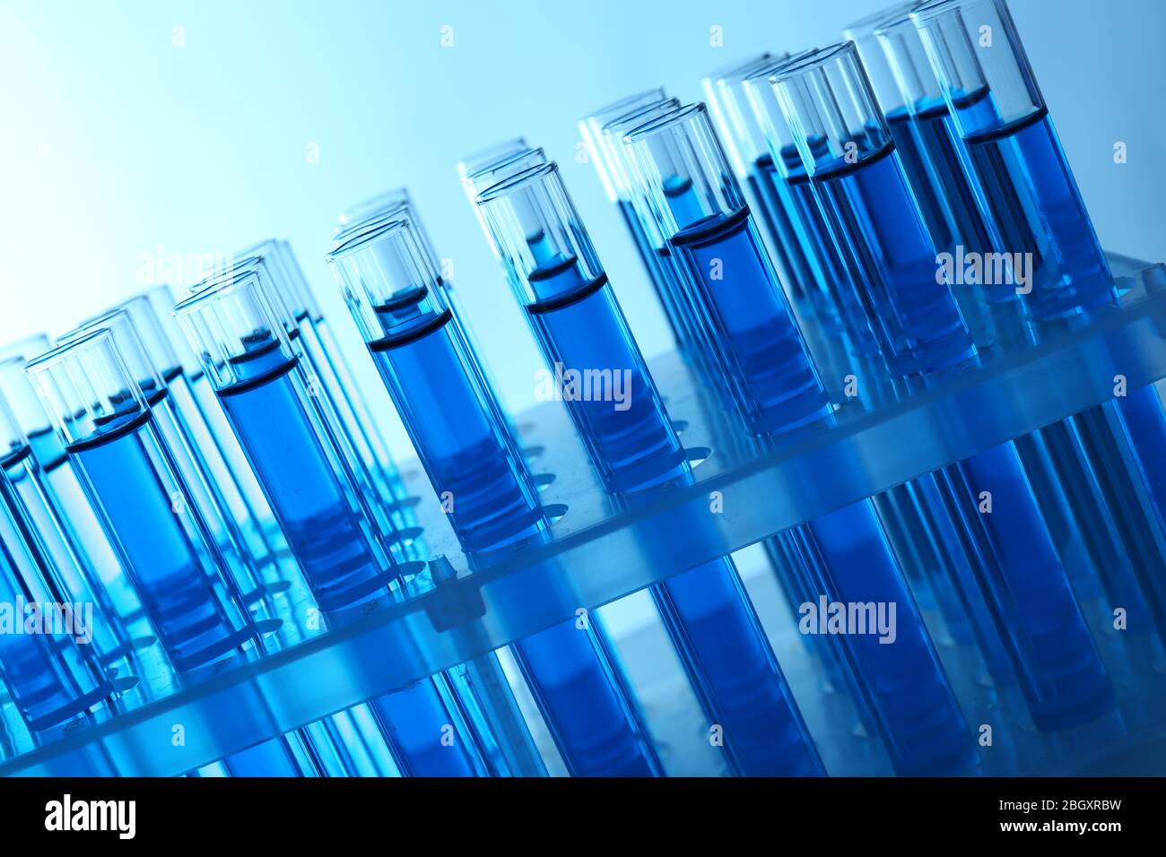 Blue water in a transparent test-tube on light background Stock Photo ...