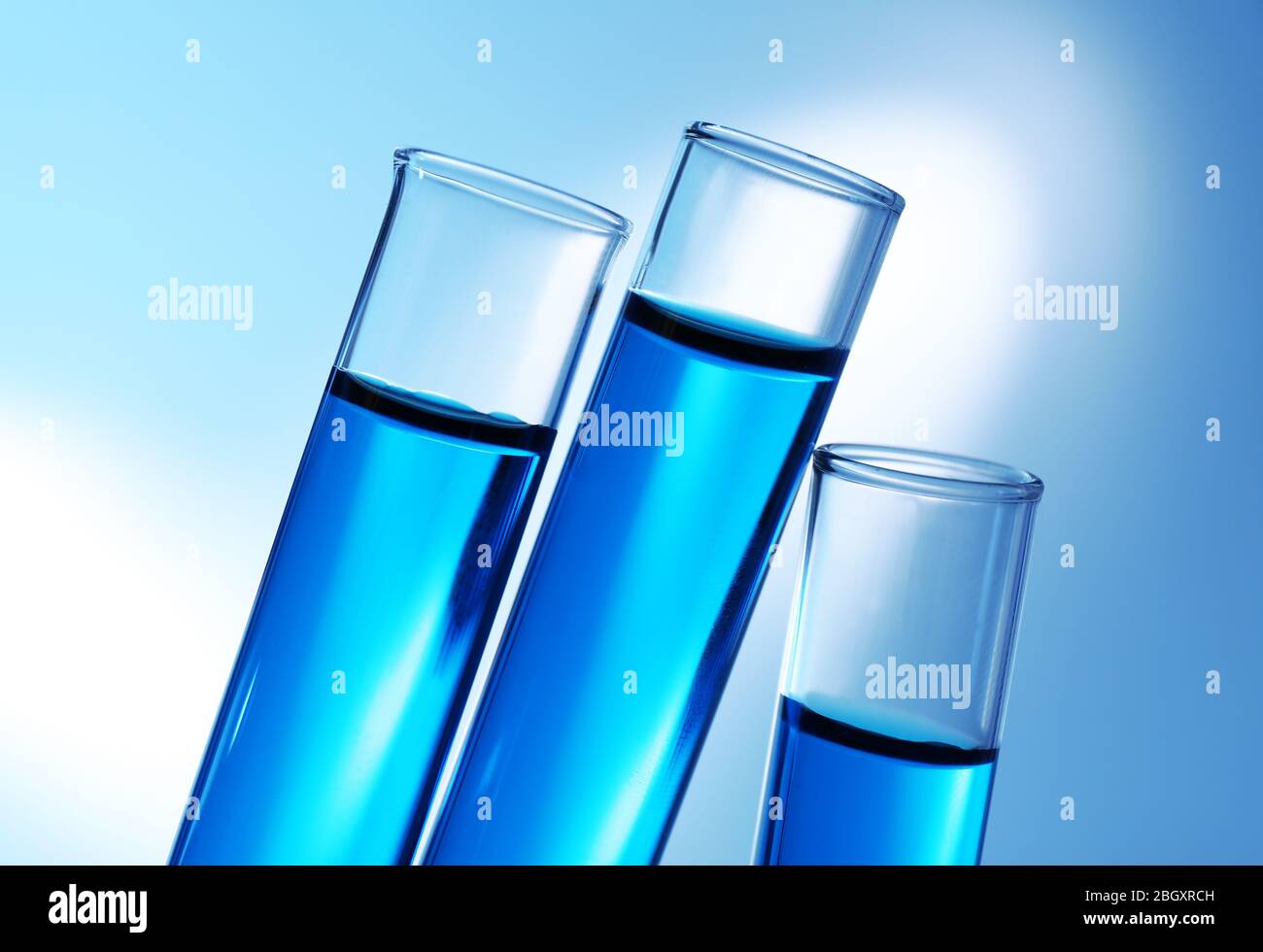 Inclined test-tubes with blue water on the shadows background Stock ...