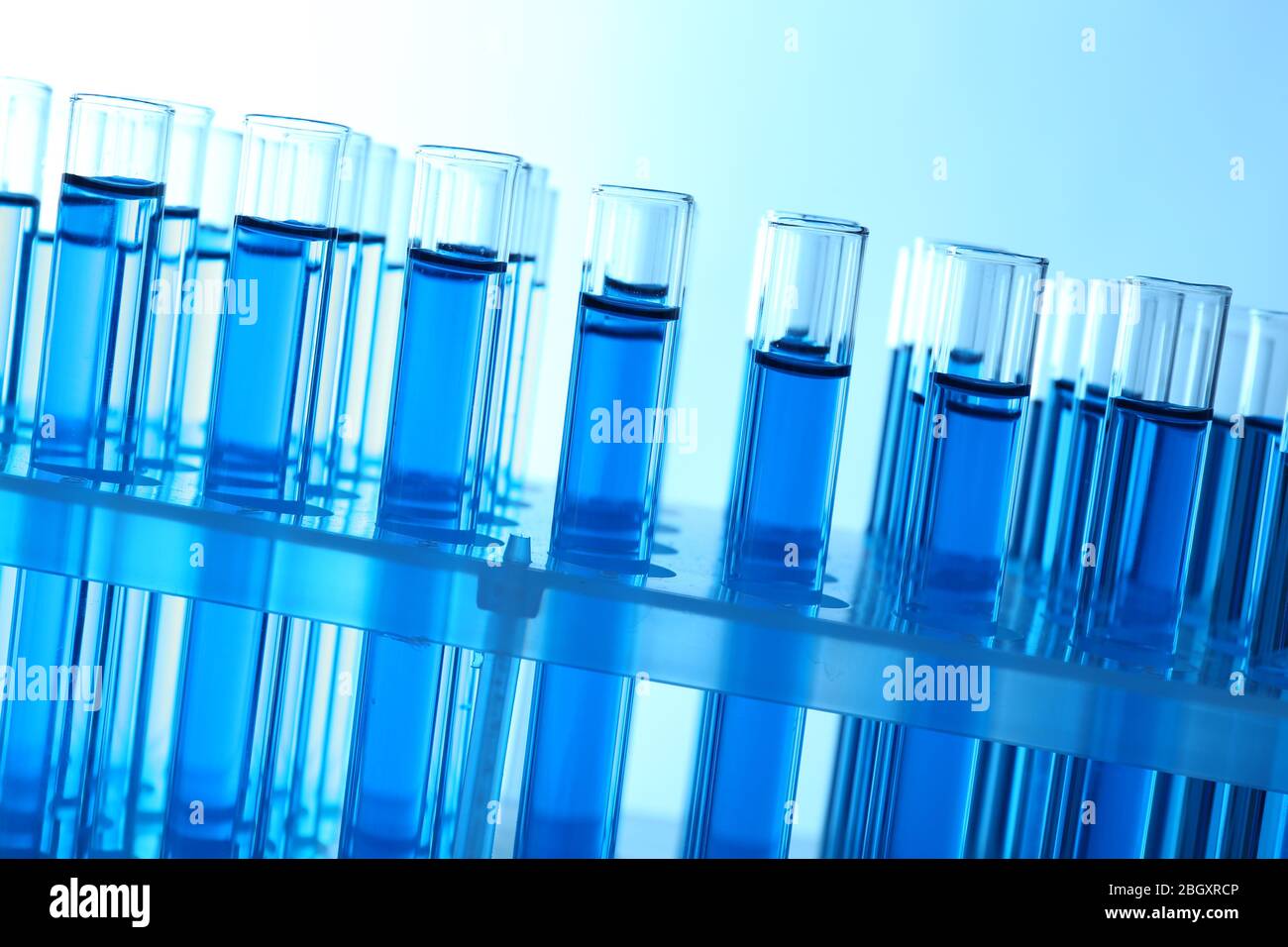 Blue water in a transparent test-tube on light background Stock Photo ...