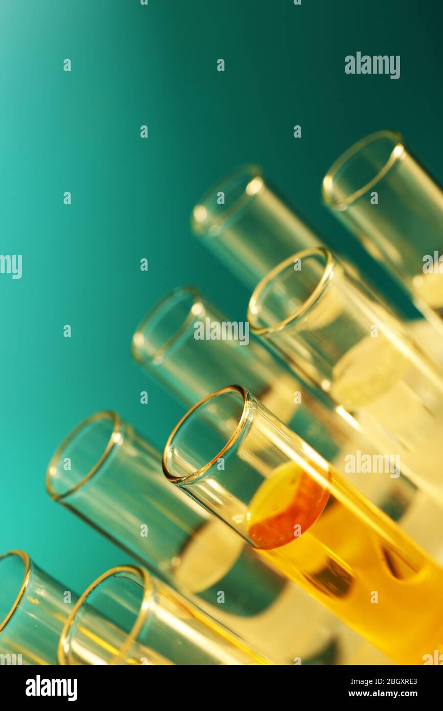 Test-tubes with colorless liquid and yellow one, on the blue background ...