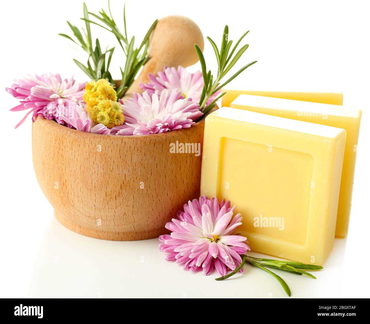 Bars of natural soap and wooden mortar with fresh herbs and flowers isolated on white Stock ...