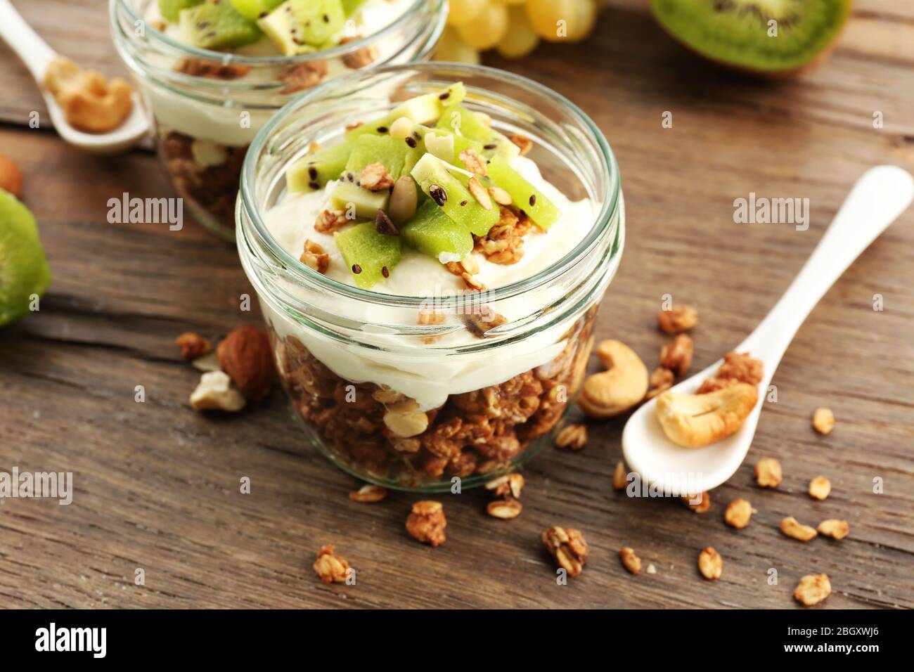 Healthy layered dessert with muesli and fruits on table Stock Photo - Alamy