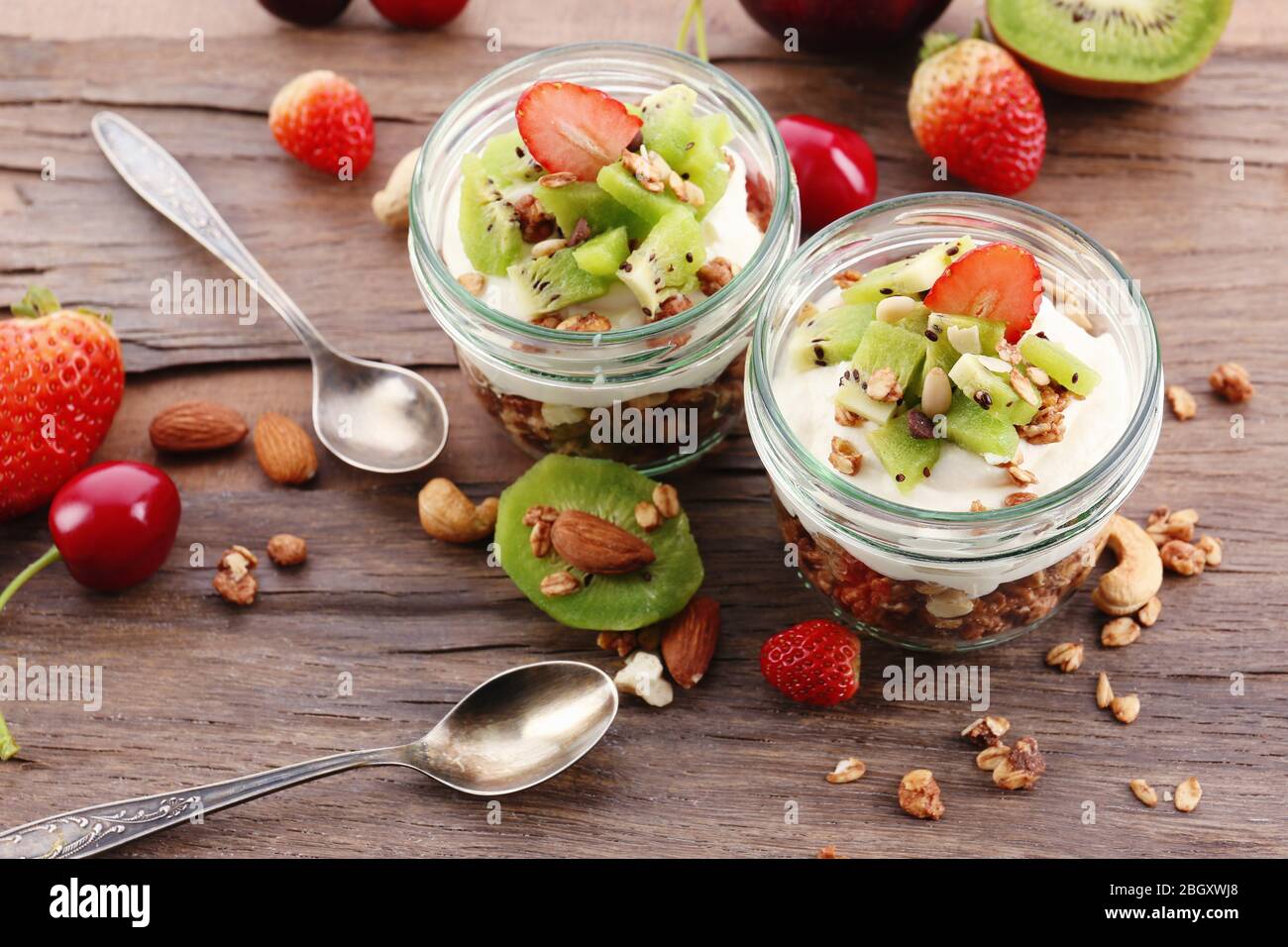 Healthy layered dessert with muesli and fruits on table Stock Photo - Alamy