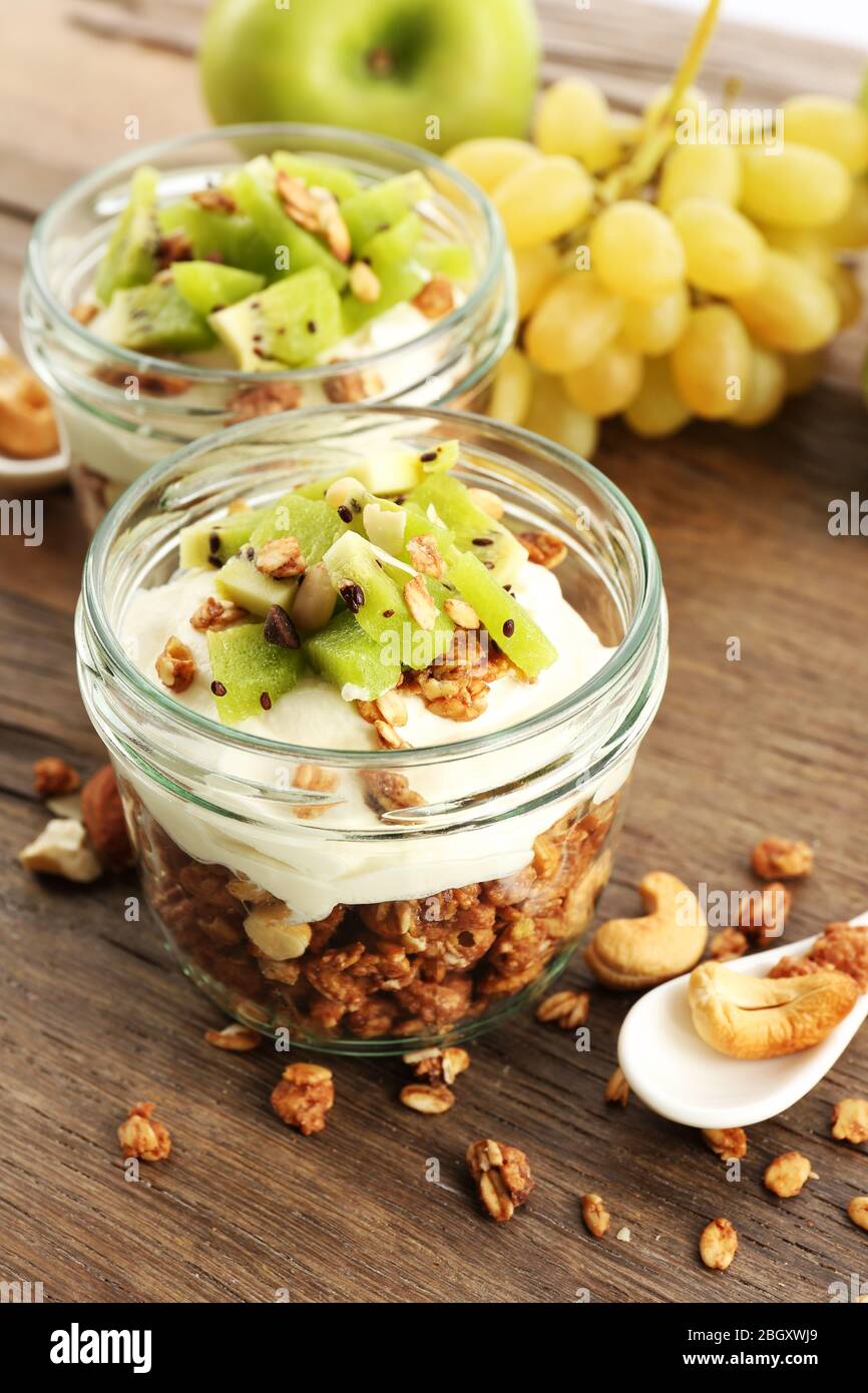 Healthy layered dessert with muesli and fruits on table Stock Photo - Alamy