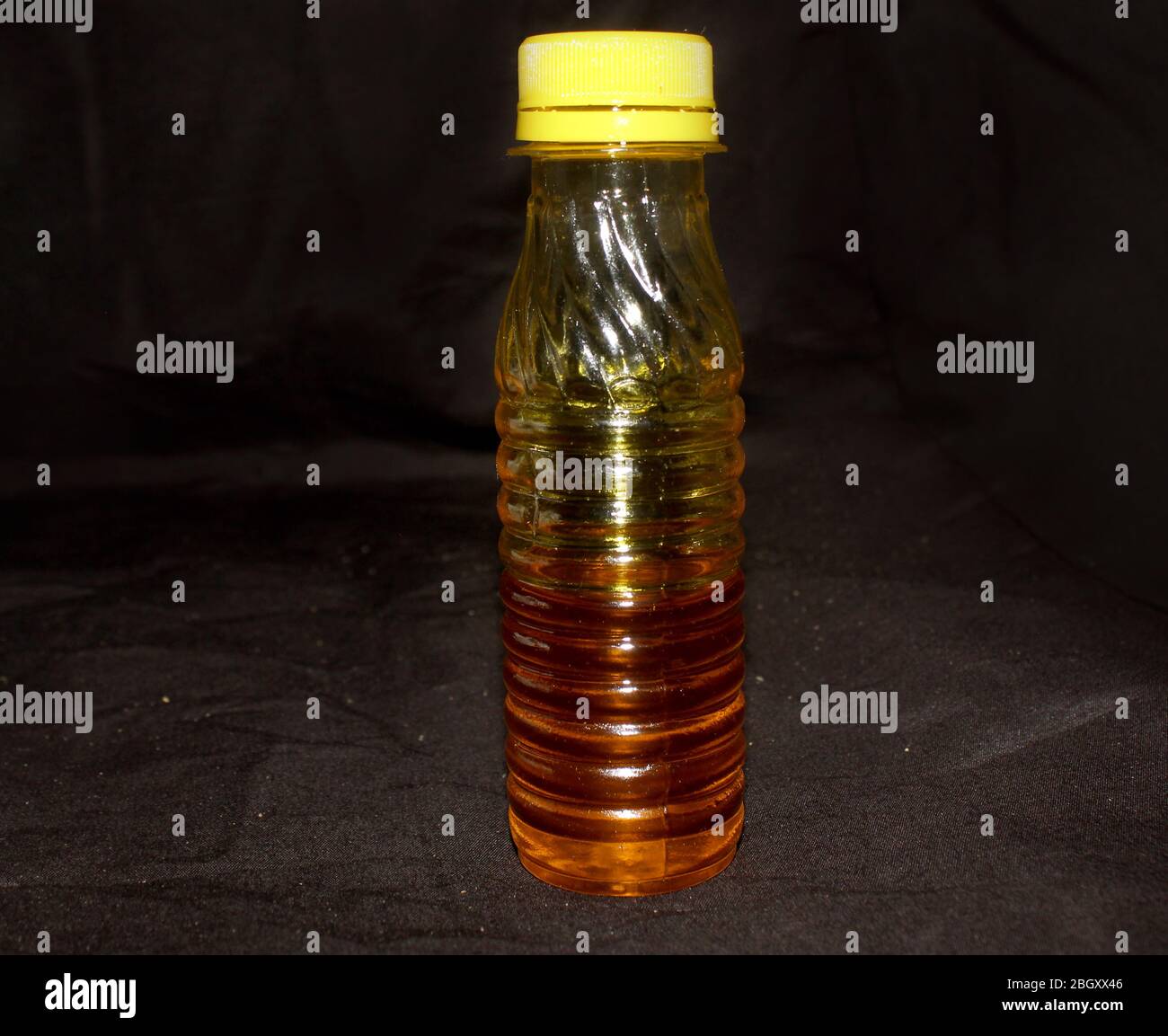 vegetable oil in plastic bottle isolated on black background Stock ...