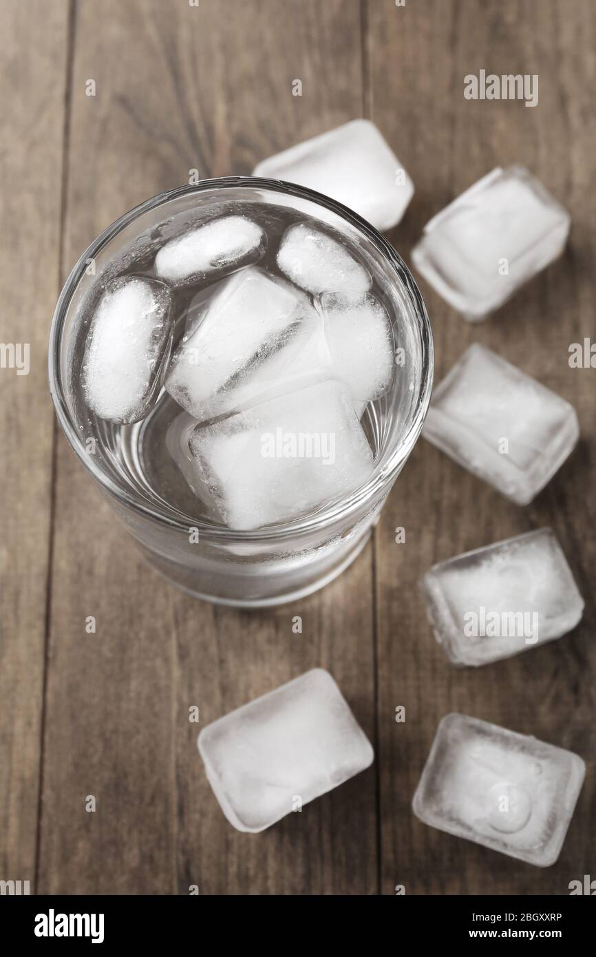 Summer cocktail with ice cubes on wooden table Stock Photo - Alamy
