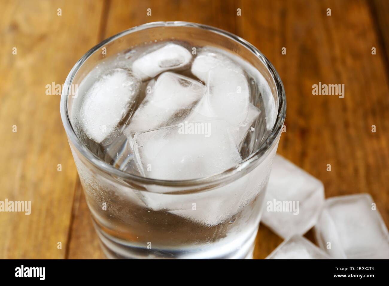 Summer cocktail with ice cubes on wooden table Stock Photo - Alamy