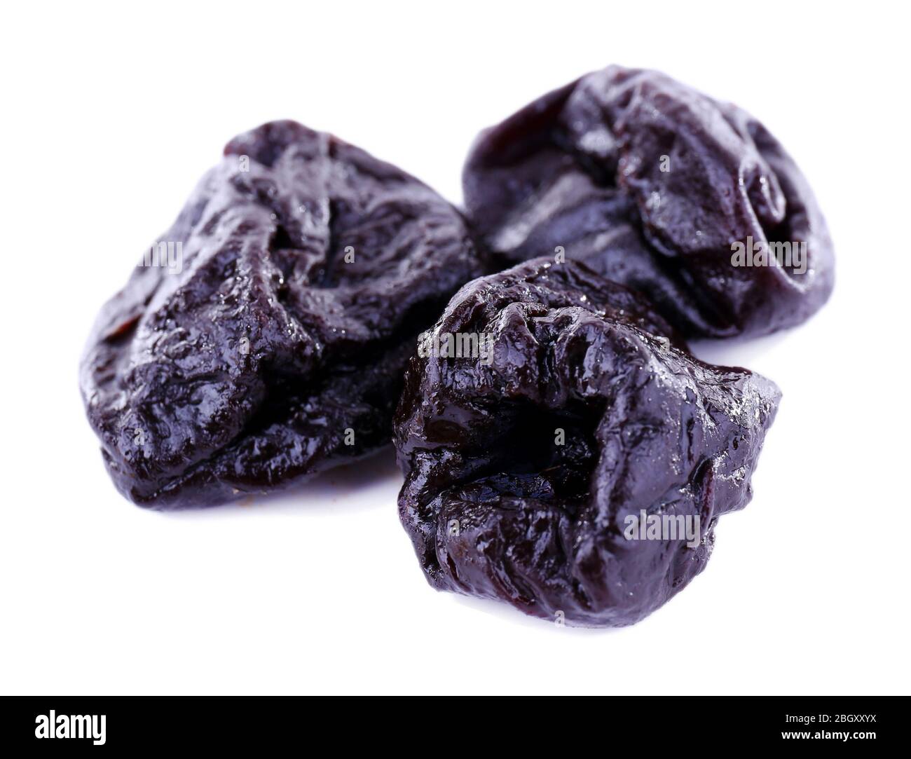 Three prunes isolated on white Stock Photo - Alamy