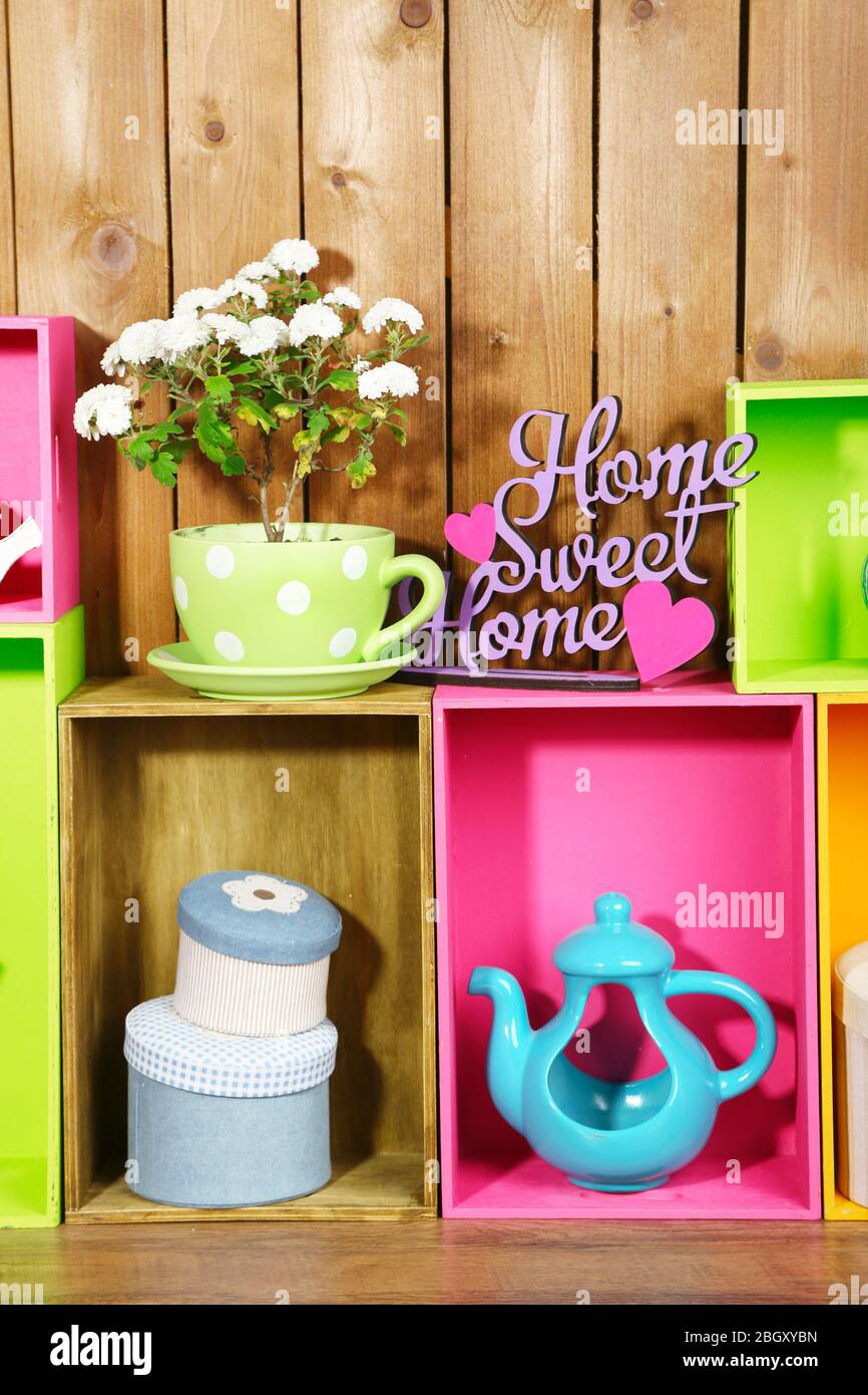 Beautiful colorful shelves with different home related objects on ...