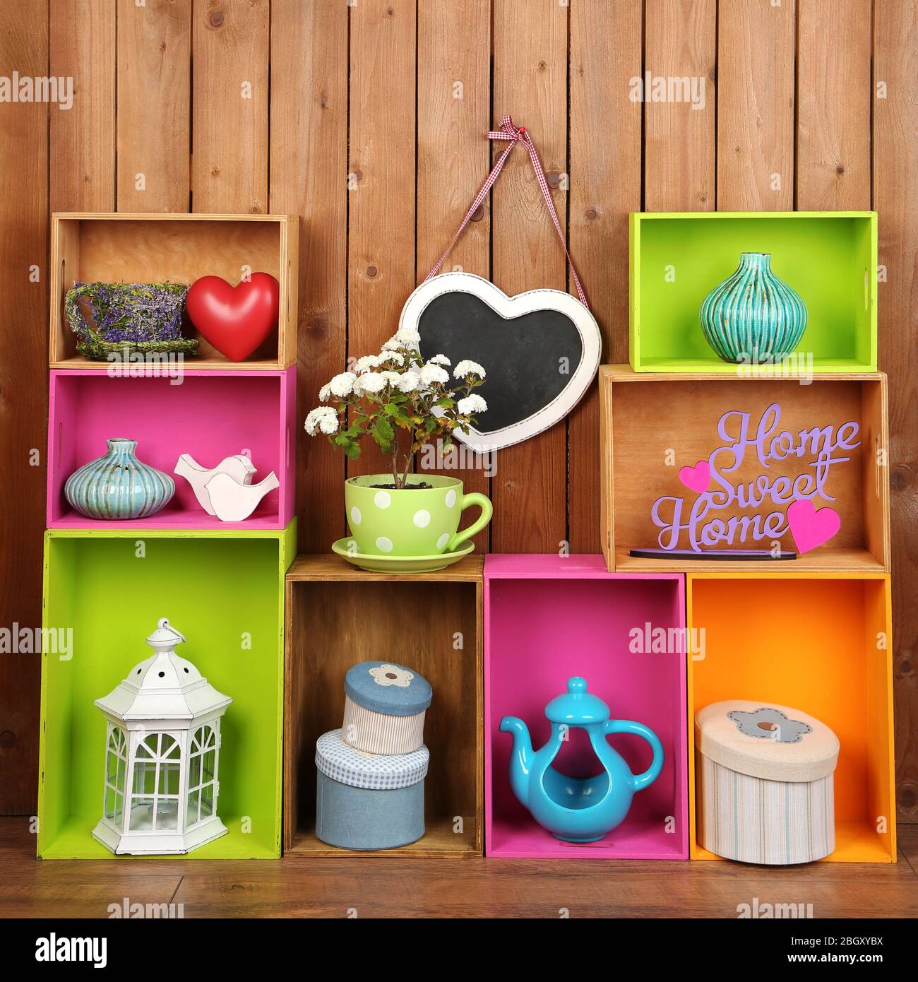 Beautiful colorful shelves with different home related objects on ...
