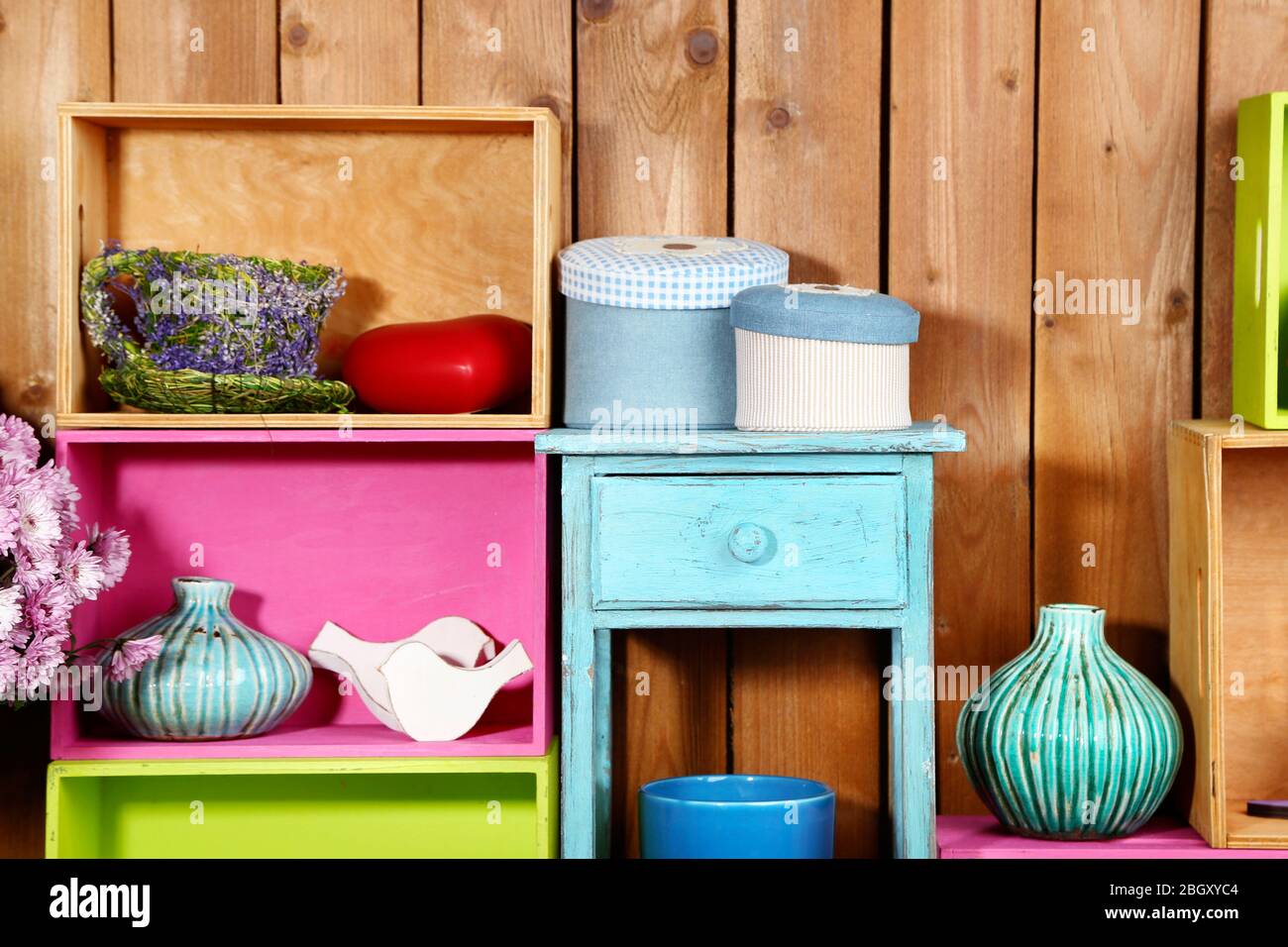 Beautiful colorful shelves with different home related objects on ...
