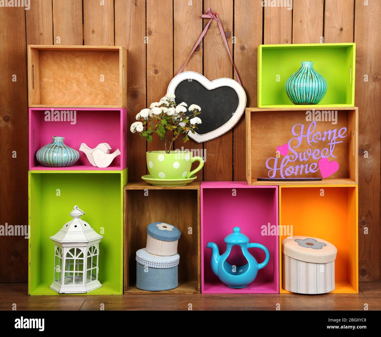Beautiful colorful shelves with different home related objects on ...