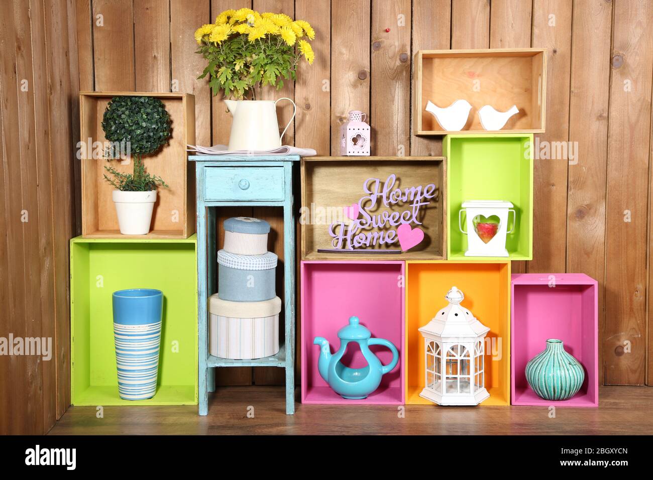 Beautiful colorful shelves with different home related objects on ...