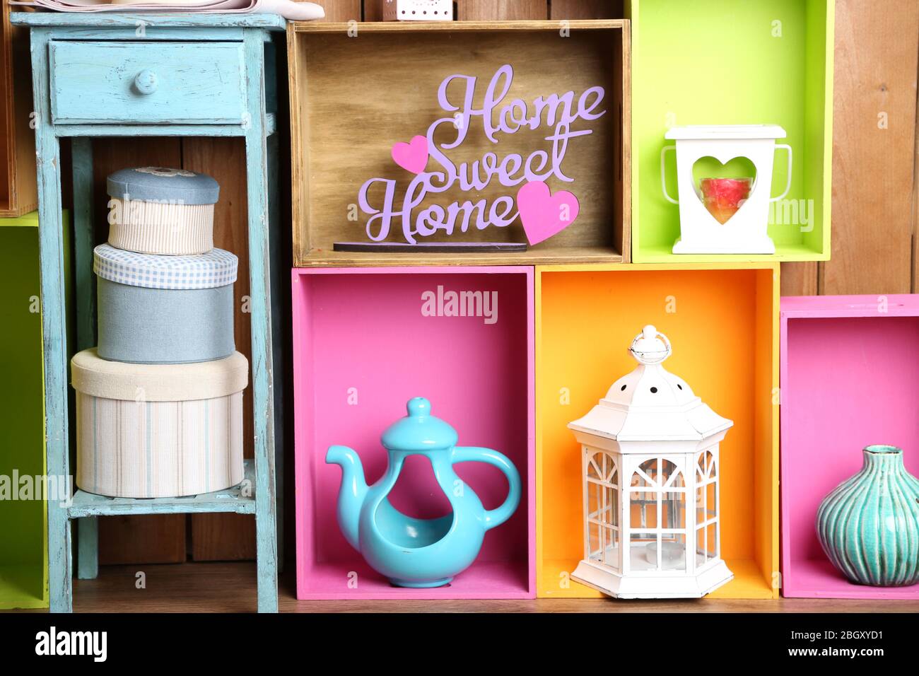 Beautiful colorful shelves with different home related objects on ...
