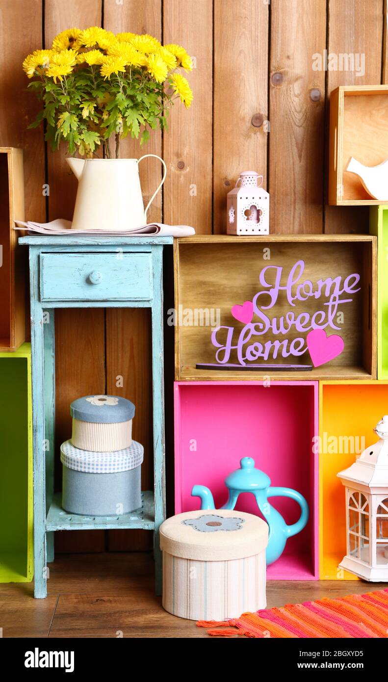 Beautiful colorful shelves with different home related objects on ...