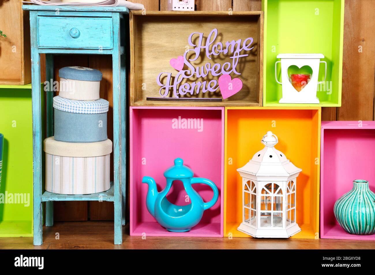 Beautiful colorful shelves with different home related objects on ...
