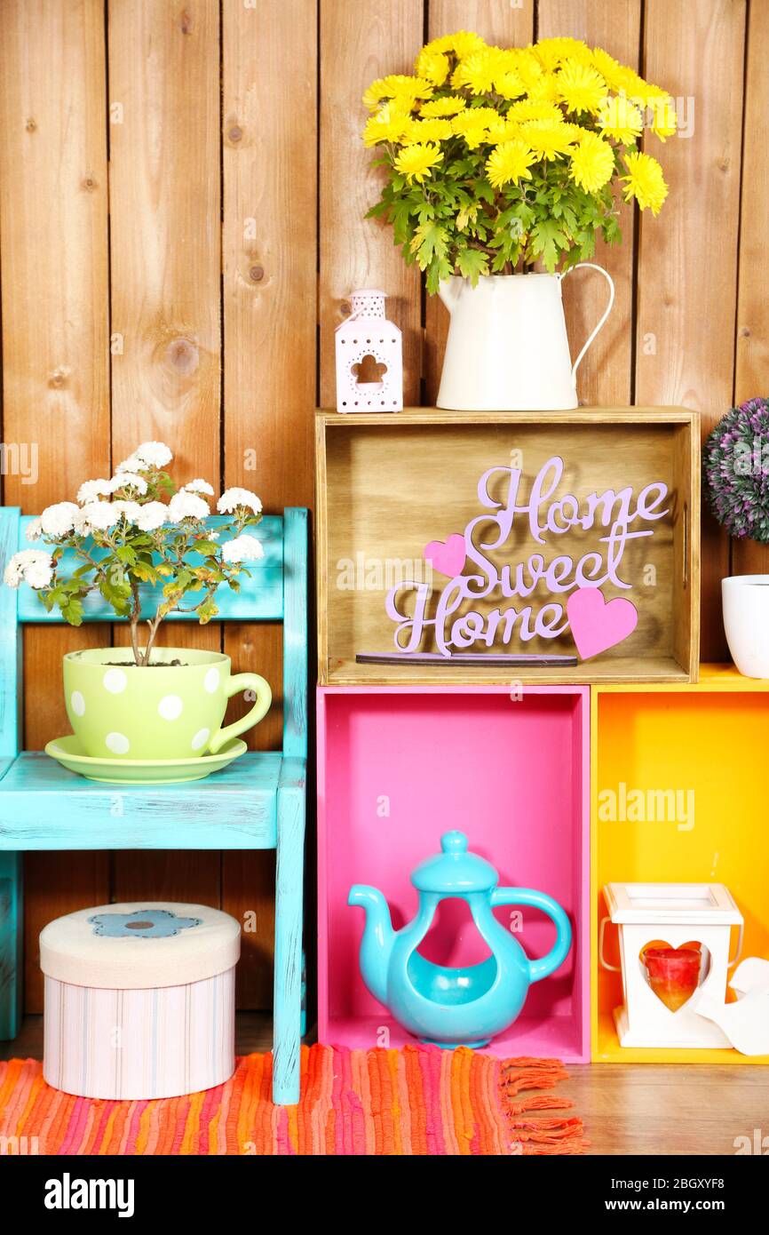 Beautiful colorful shelves with different home related objects on ...