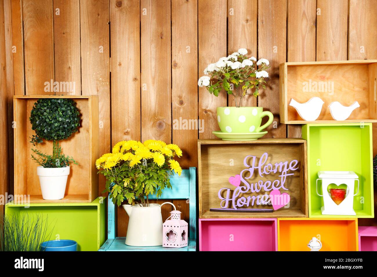 Beautiful colorful shelves with different home related objects on ...