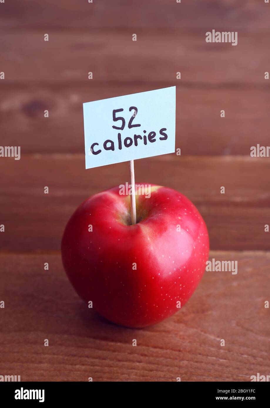Red apple with calories count label on wooden table background Stock ...
