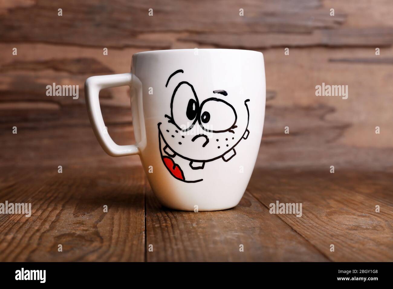 Emotional cup on wooden background Stock Photo - Alamy