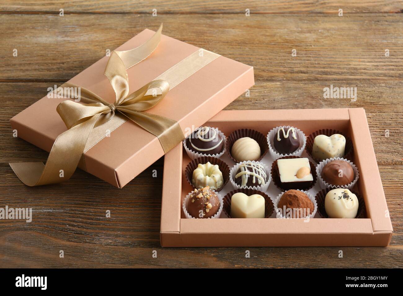 Delicious chocolate candies in gift box on table close-up Stock Photo ...