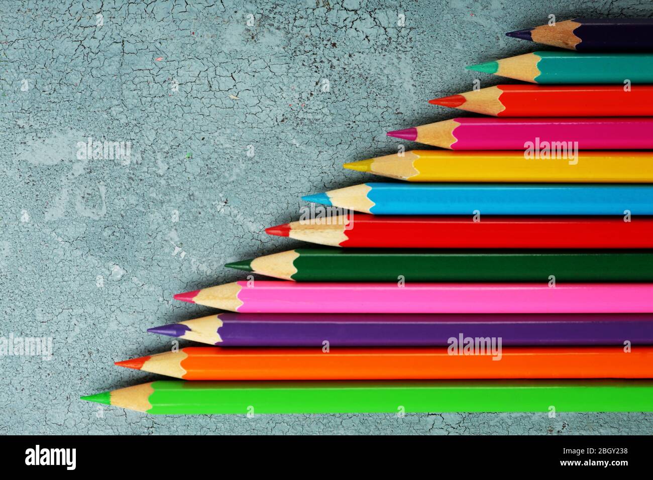 Colorful pencils on texture wooden background Stock Photo - Alamy