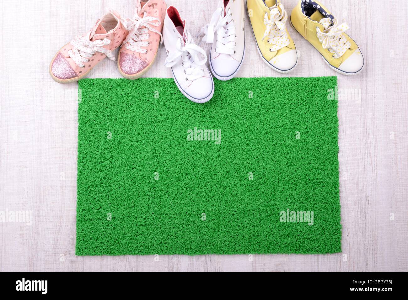 Green carpet on floor and converse close-up Stock Photo - Alamy