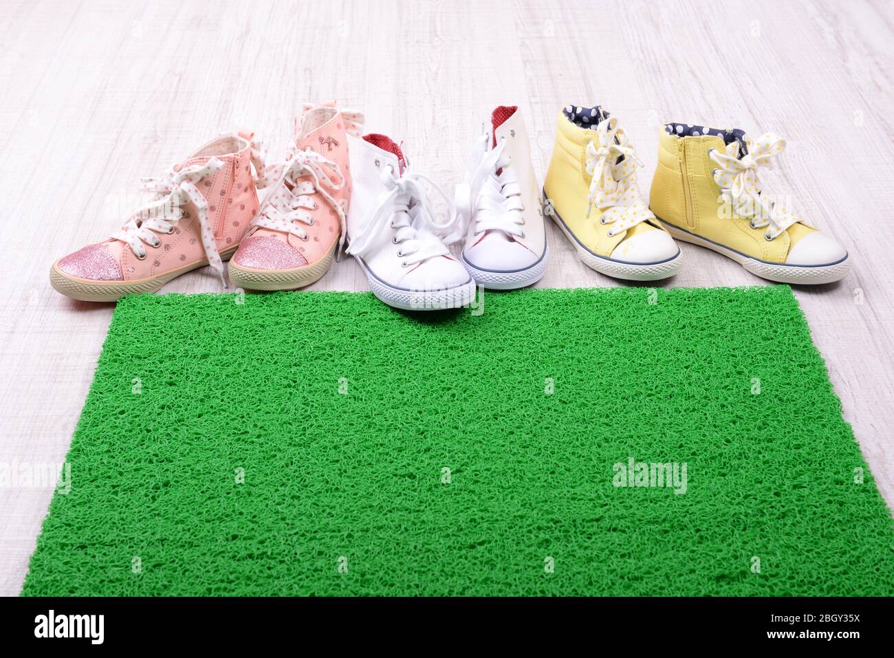 Green carpet on floor and converse close-up Stock Photo - Alamy