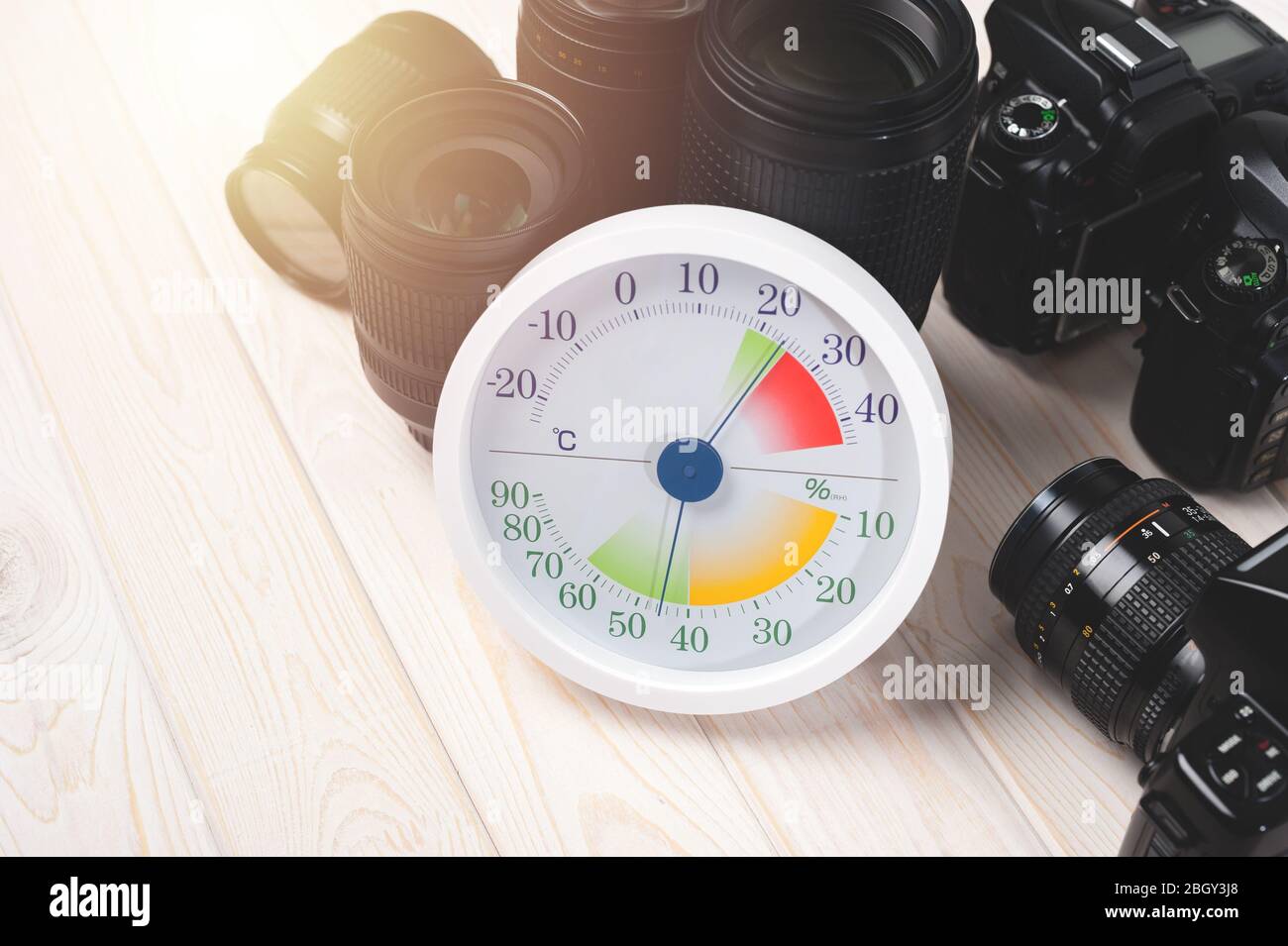 white analog Thermometer and Hygrometer with photography equipments ...