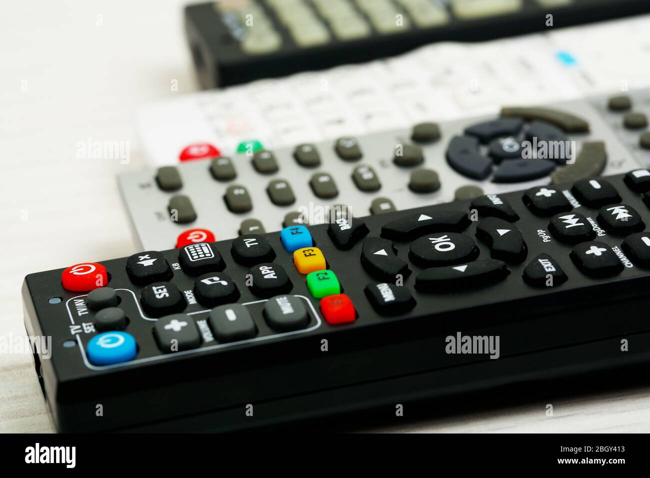 Many remote control devices on table Stock Photo - Alamy