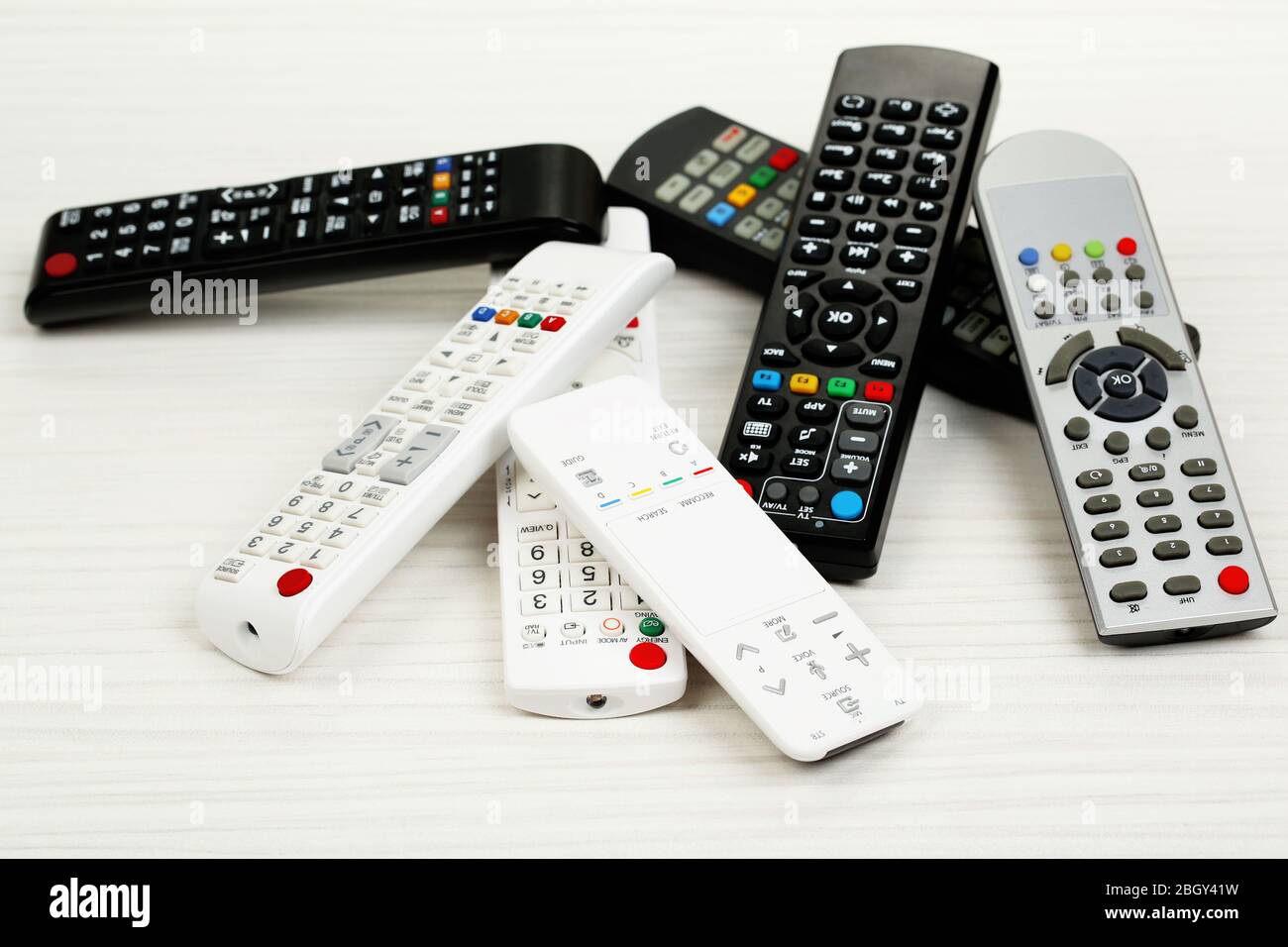 Many remote control devices on table Stock Photo - Alamy