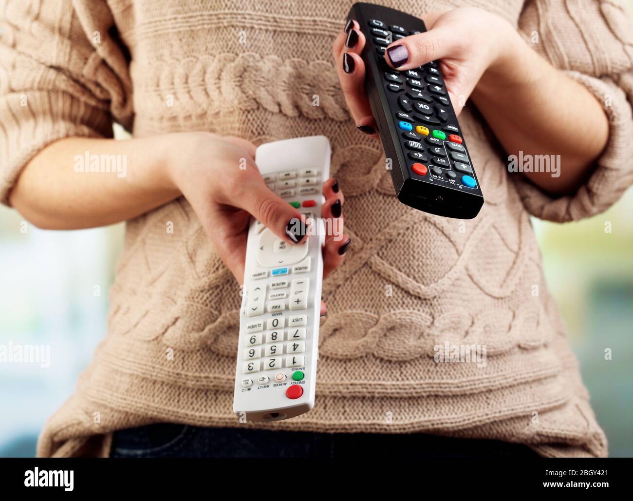 Many remote control devices in in hands Stock Photo - Alamy
