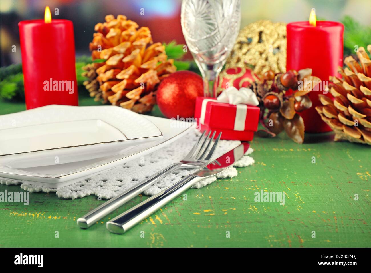 Table appointments with present box and Christmas decoration background ...