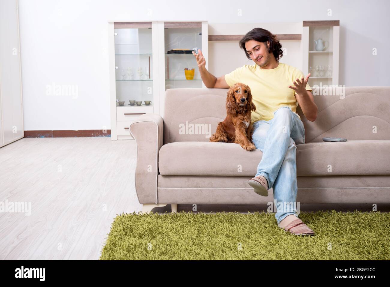 Young man with cocker spaniel Stock Photo - Alamy