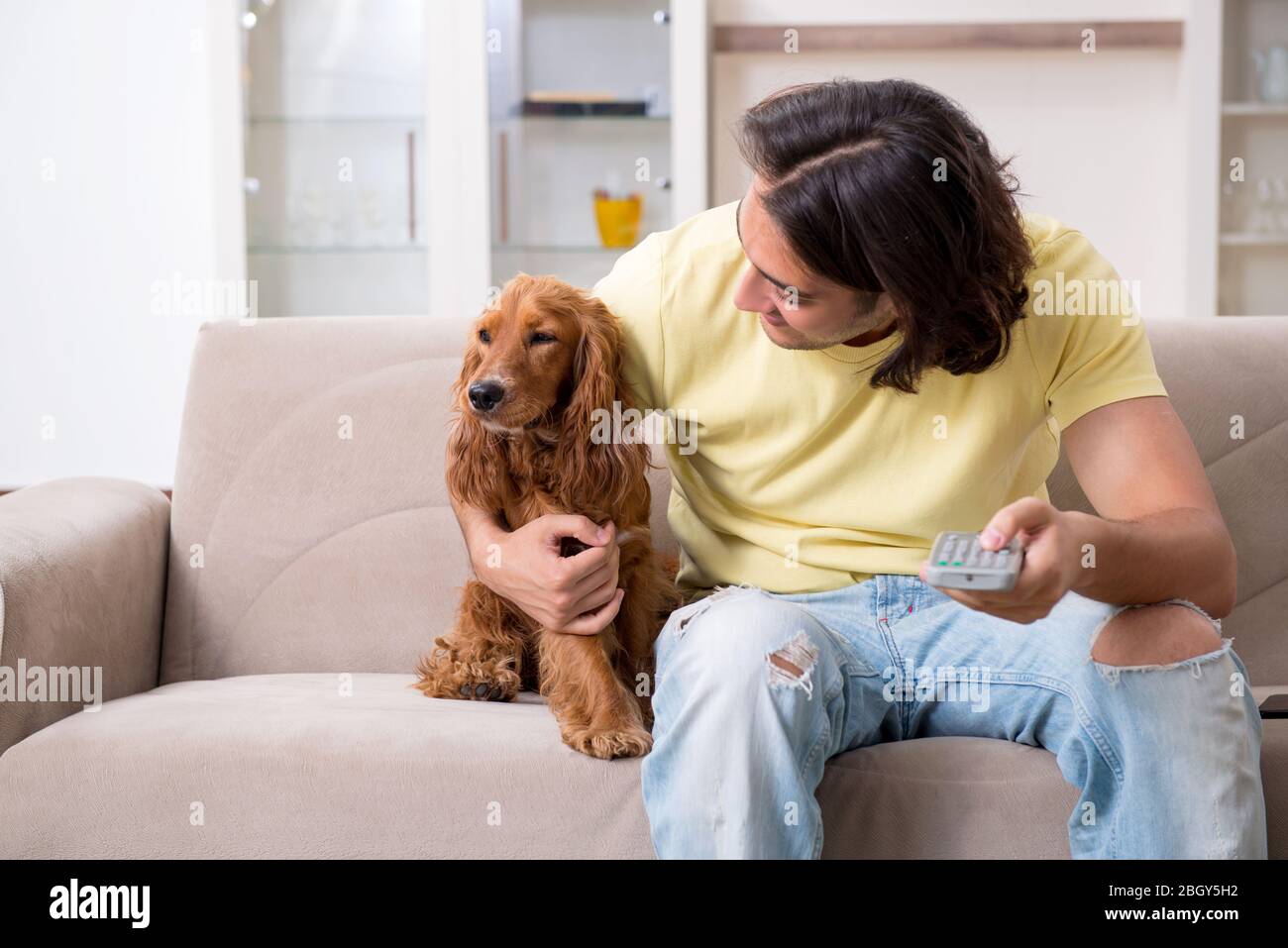 Young man with cocker spaniel Stock Photo - Alamy