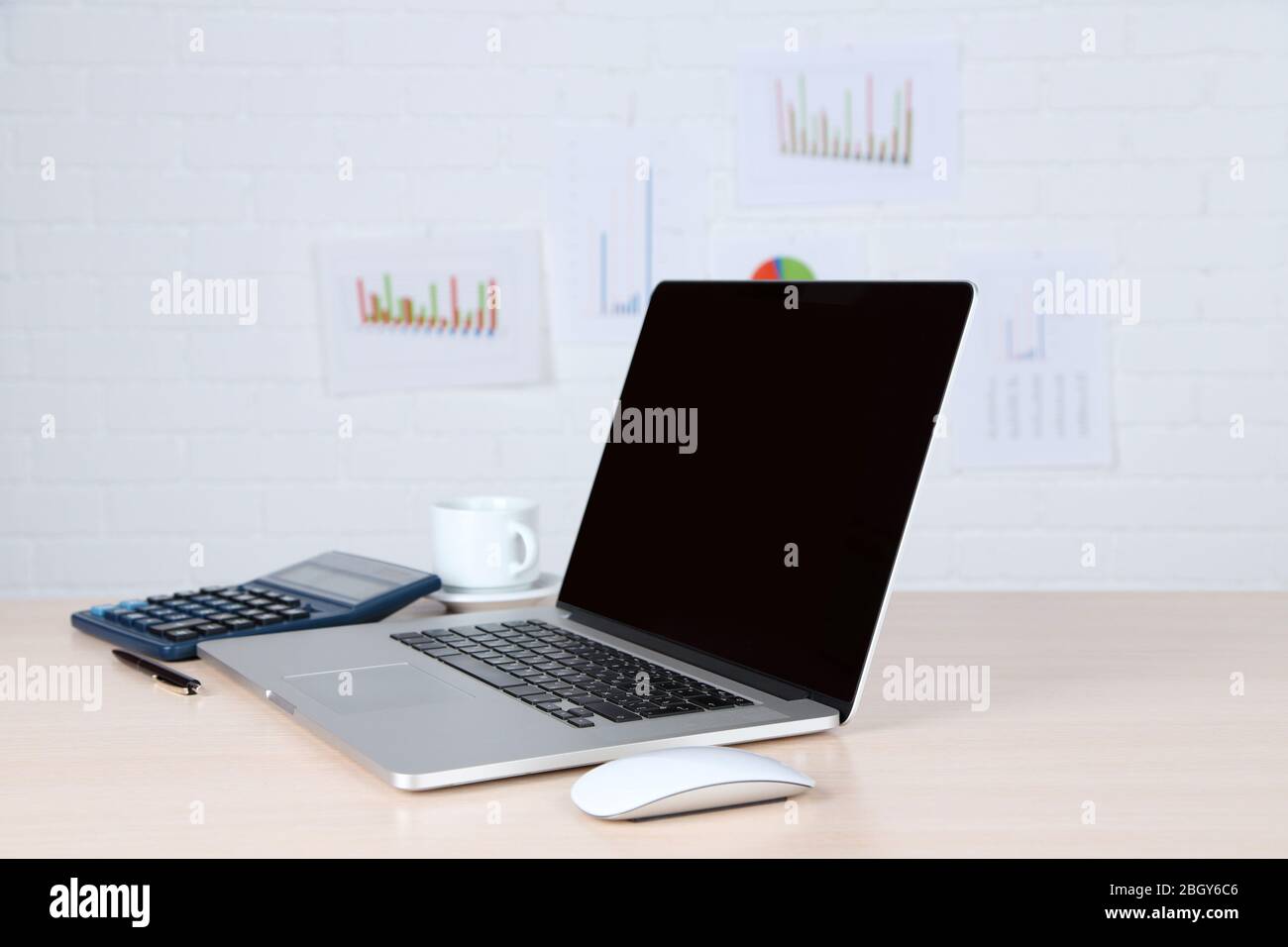 Modern laptop on table, on white wall background Stock Photo - Alamy