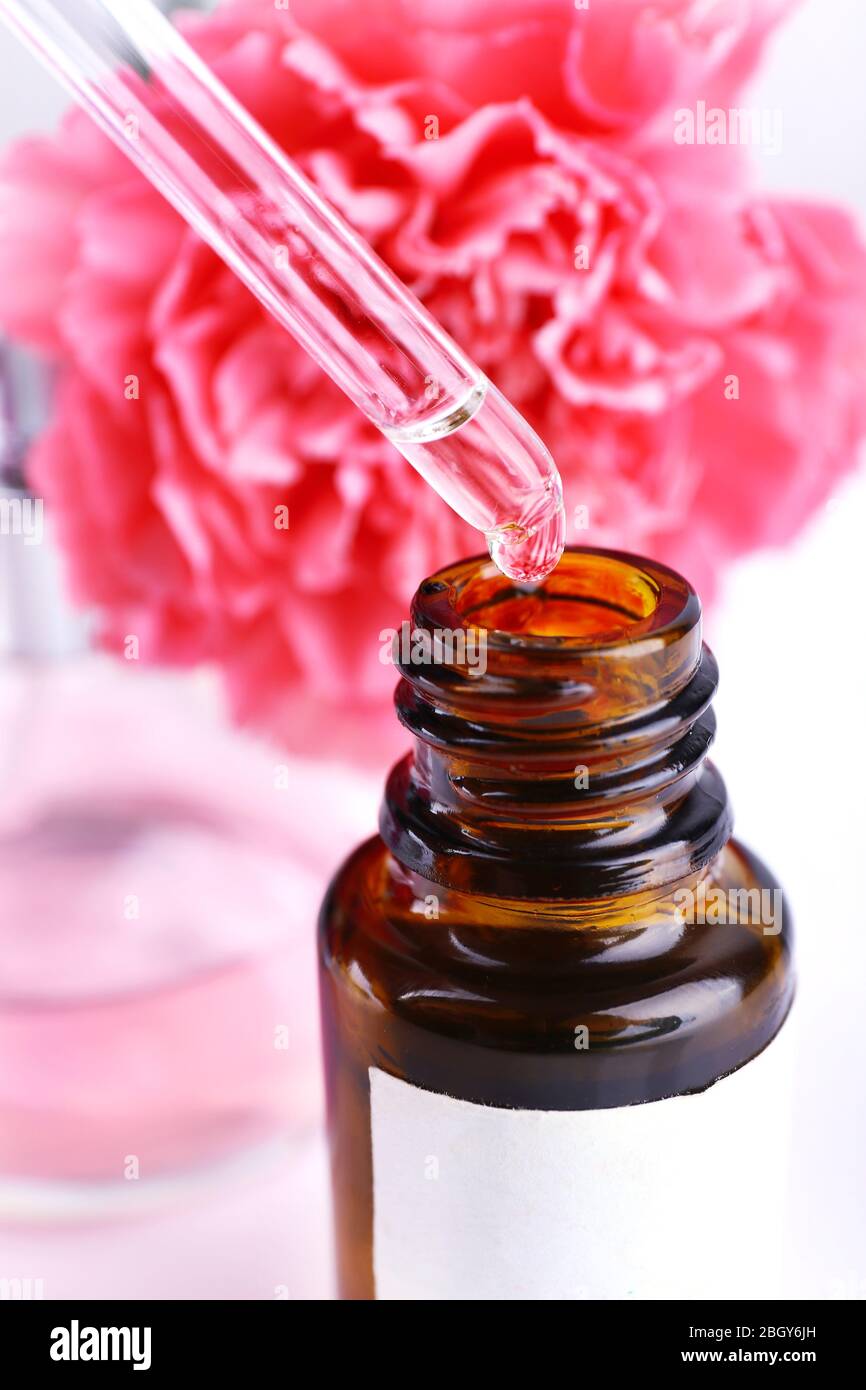 Dropper bottle of perfume with clove on white background Stock Photo ...