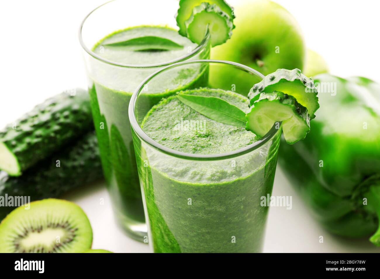 Green fresh healthy juice with fruits and vegetables on white ...