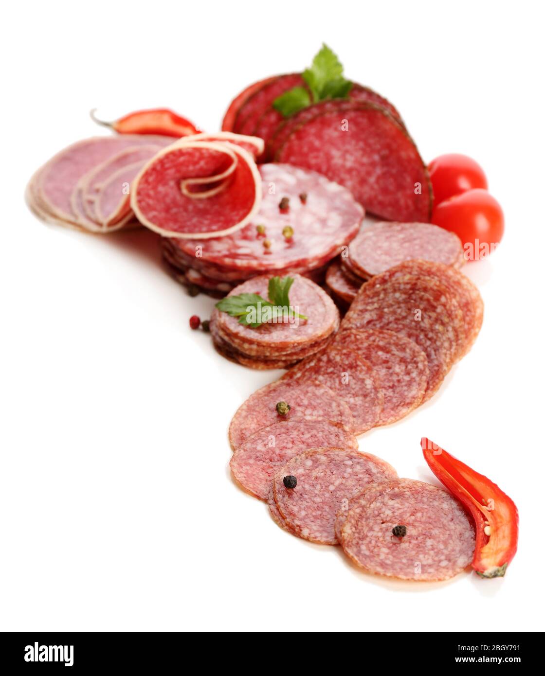 Various sliced salami with chili pepper, cherry tomatoes and spices ...